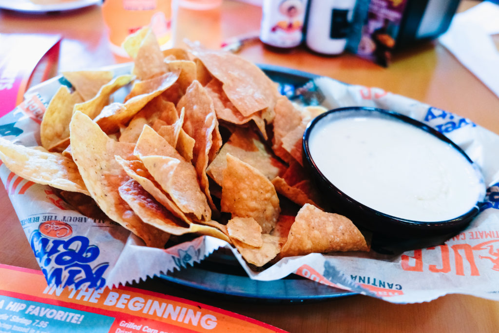 Try the best street tacos + mile-high nachos at Nacho Hippo